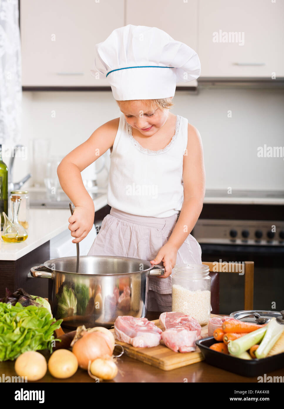 Funny girl cooking food at domestic kitchen Stock Photo - Alamy
