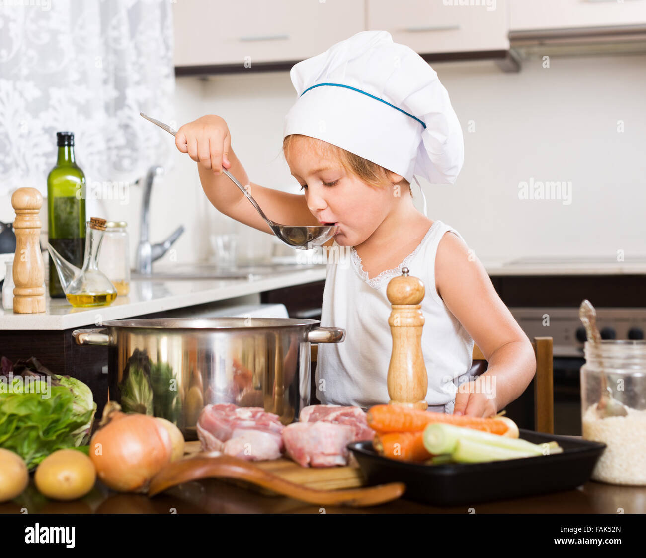 Little girl prepared soup with vegetables at kitchen Stock Photo - Alamy