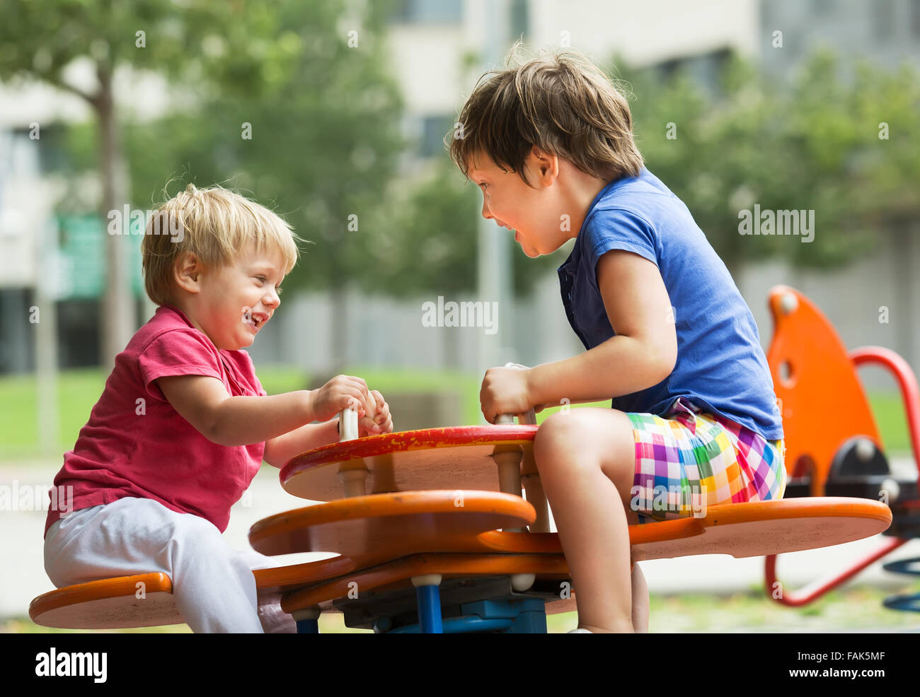 Happy laughing children having fun at playground Stock Photo - Alamy