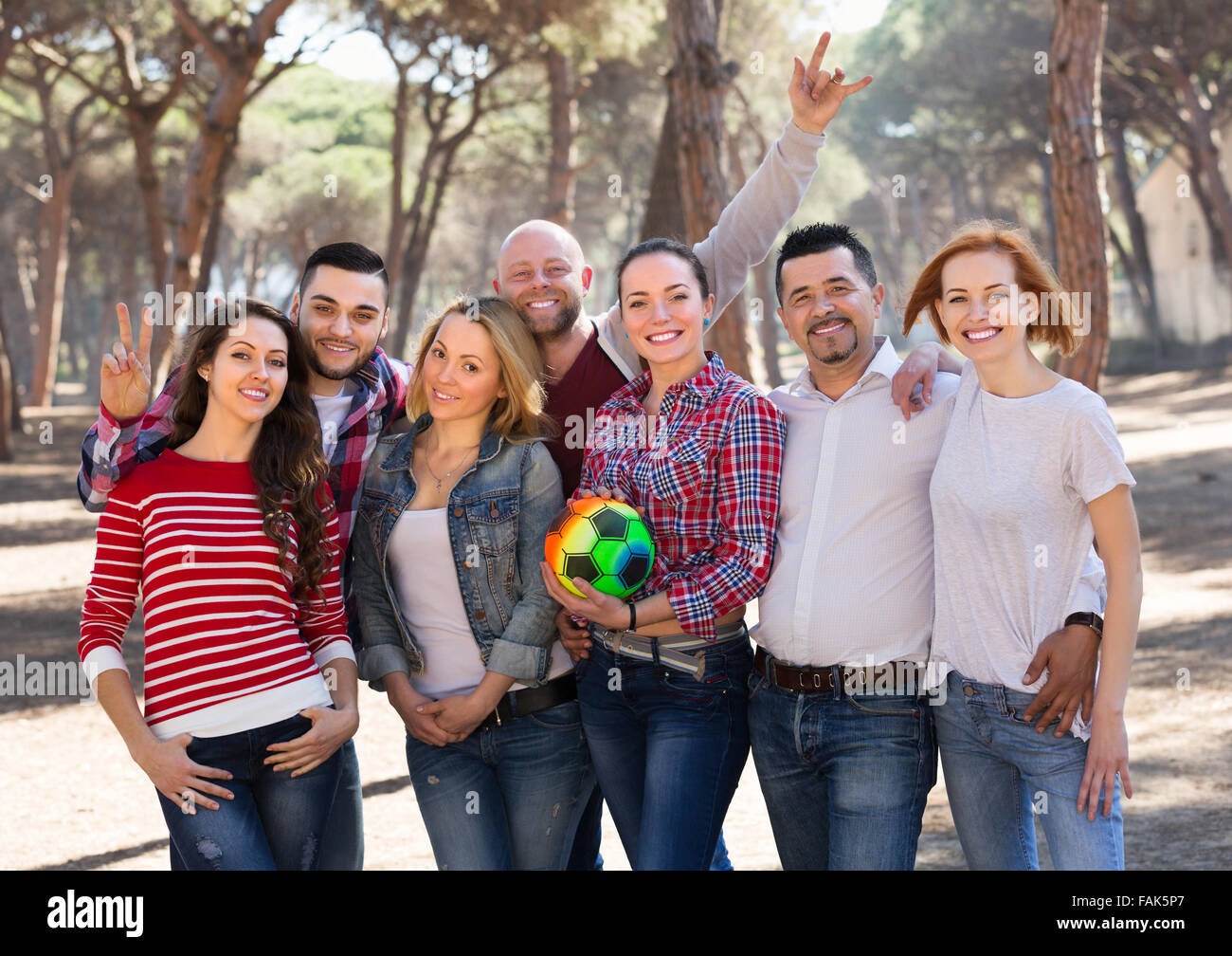 Happy friends chasing ball outdoors at sunny day Stock Photo - Alamy