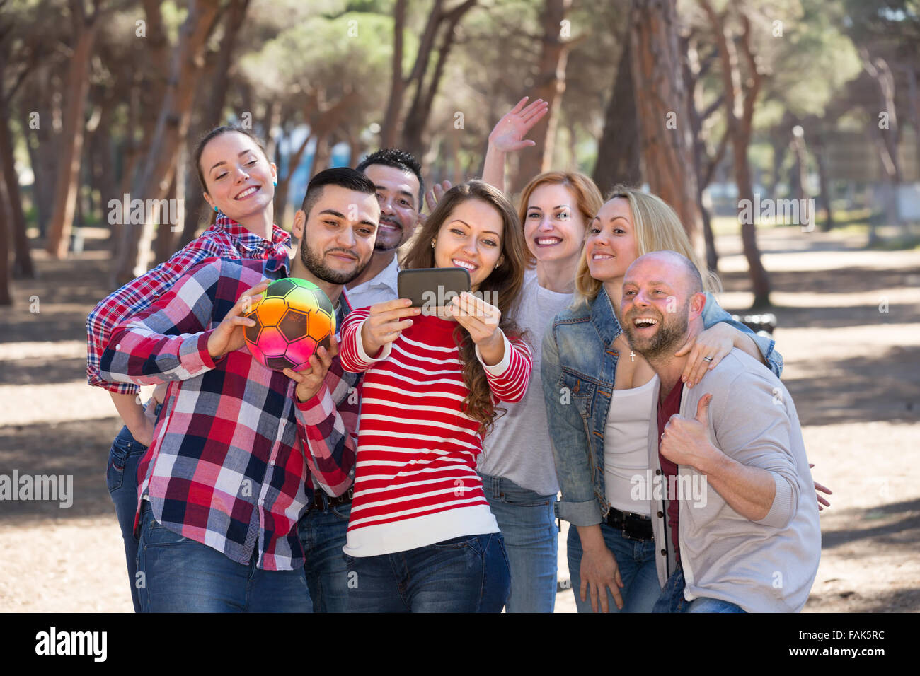 Group of friends taking pictures together at countryside Stock Photo ...