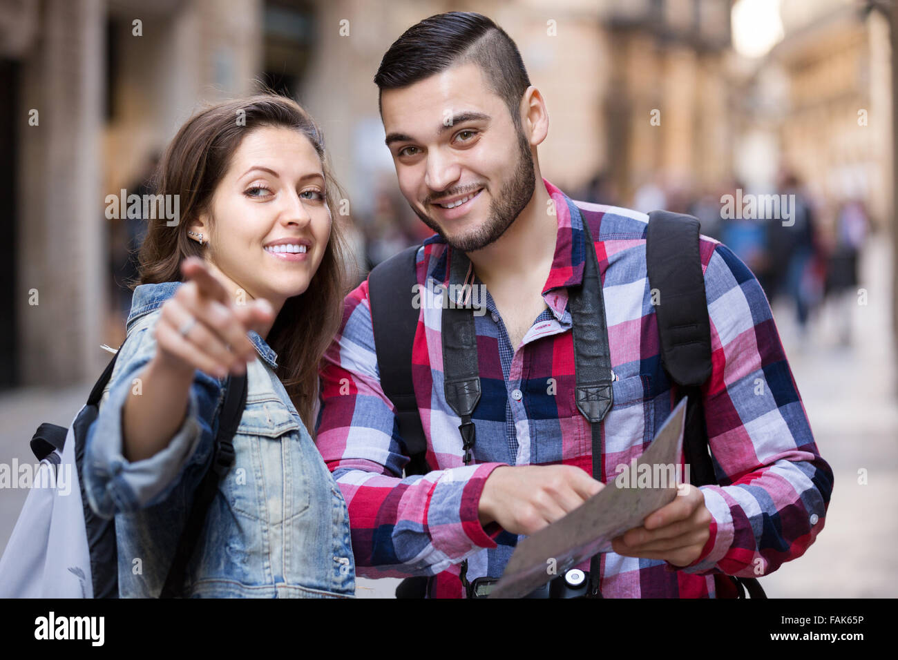 Happy young girl points the direction at the city Stock Photo - Alamy