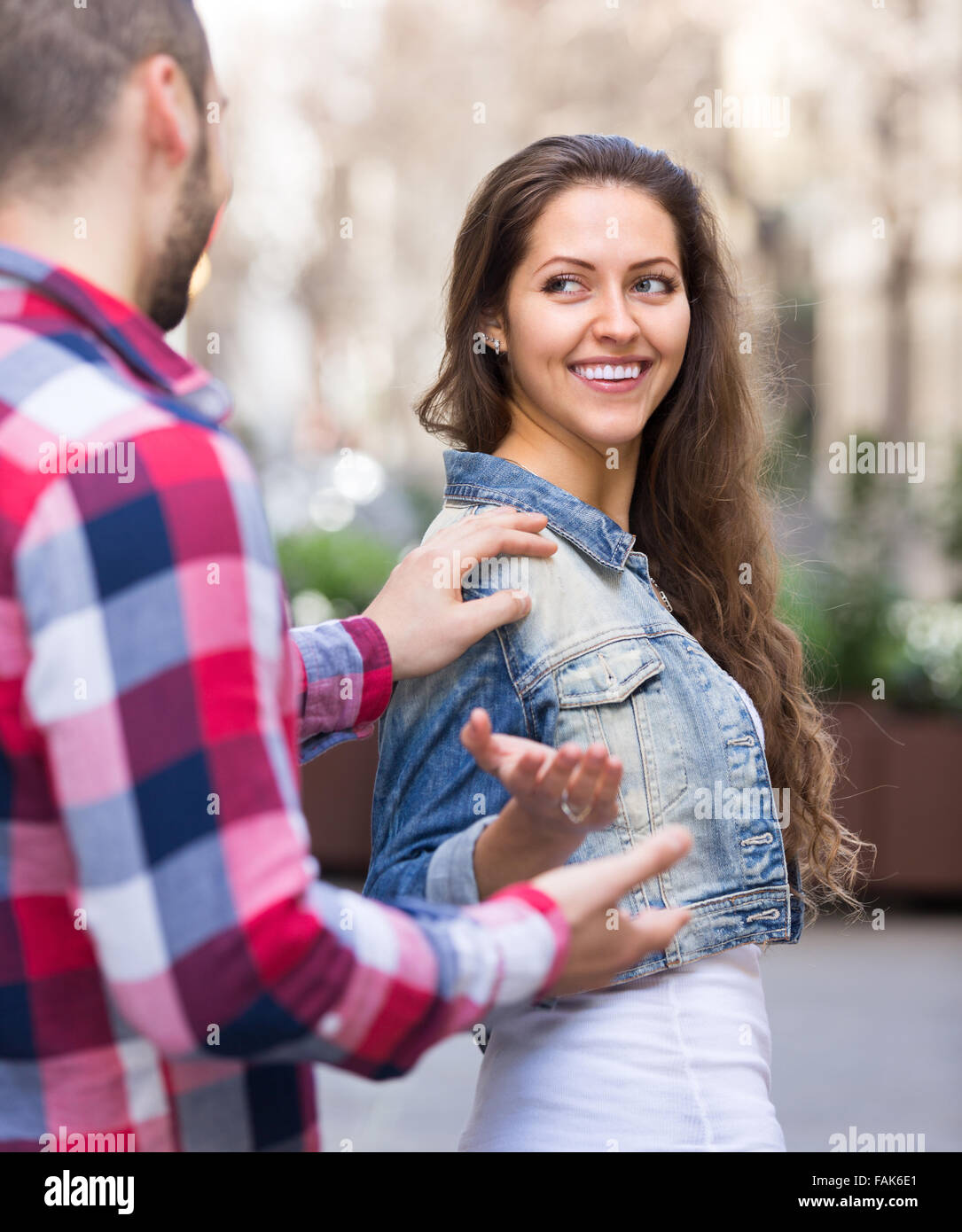 Happy girl smiling back at nice-looking male stranger Stock Photo - Alamy
