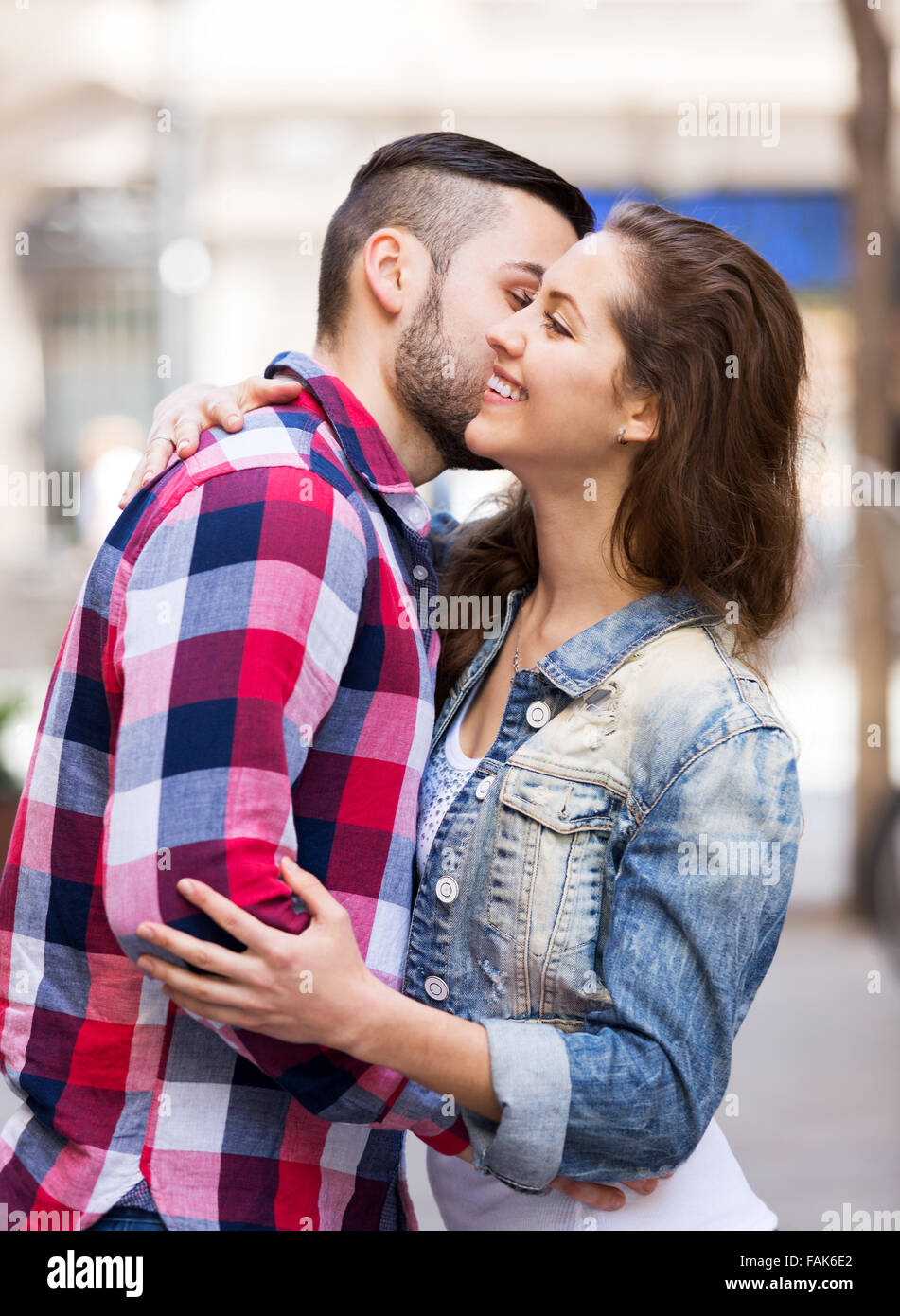 Young man meeting his girlfriend at city street Stock Photo - Alamy
