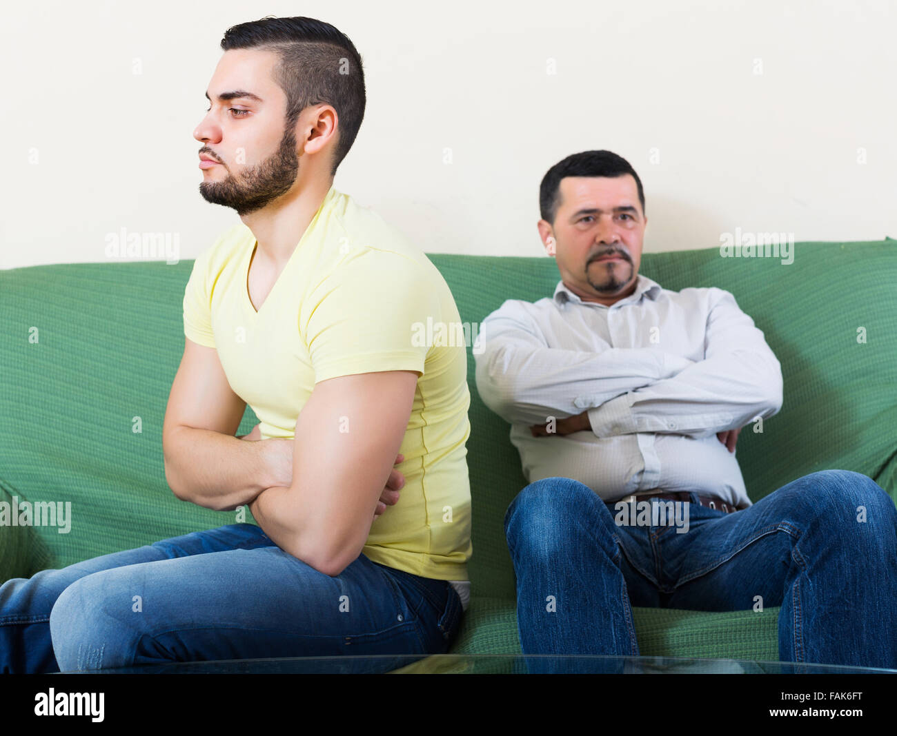 Two male adults arguing about something indoors Stock Photo - Alamy