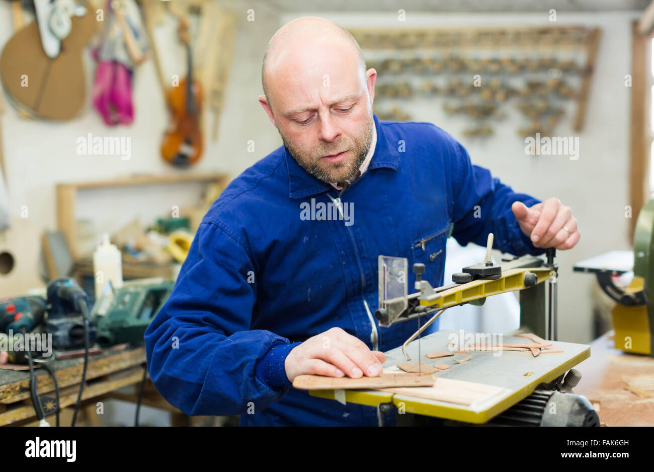 Professional woodworker working on a machine at wood workshop Stock ...