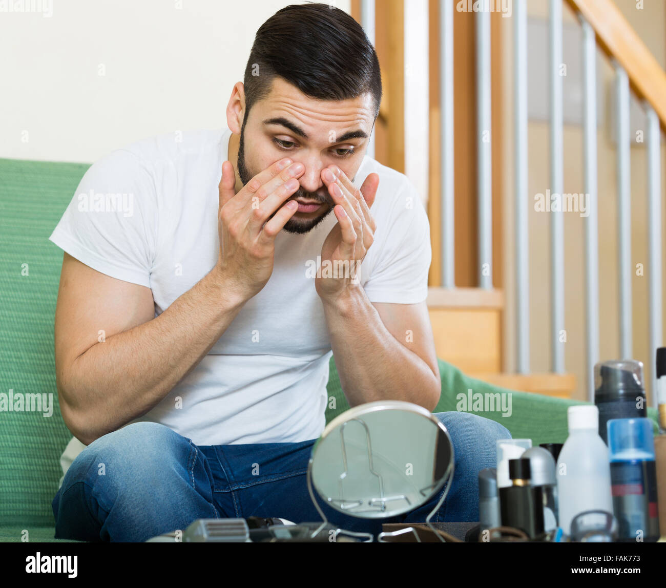 adult american guy looking at his problematic skin in a mirror Stock ...