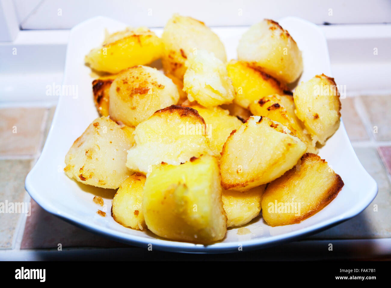 Roast potatoes roasted cooked cooking spuds on plate crispy edges ready ...