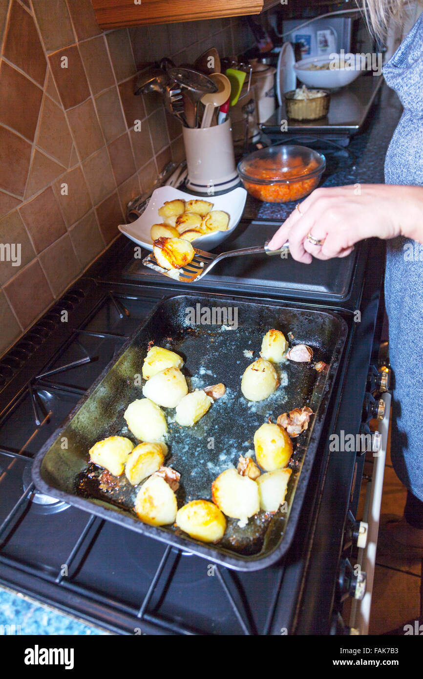 Roast potatoes roasted cooked cooking serving up roasting tray spuds on ...