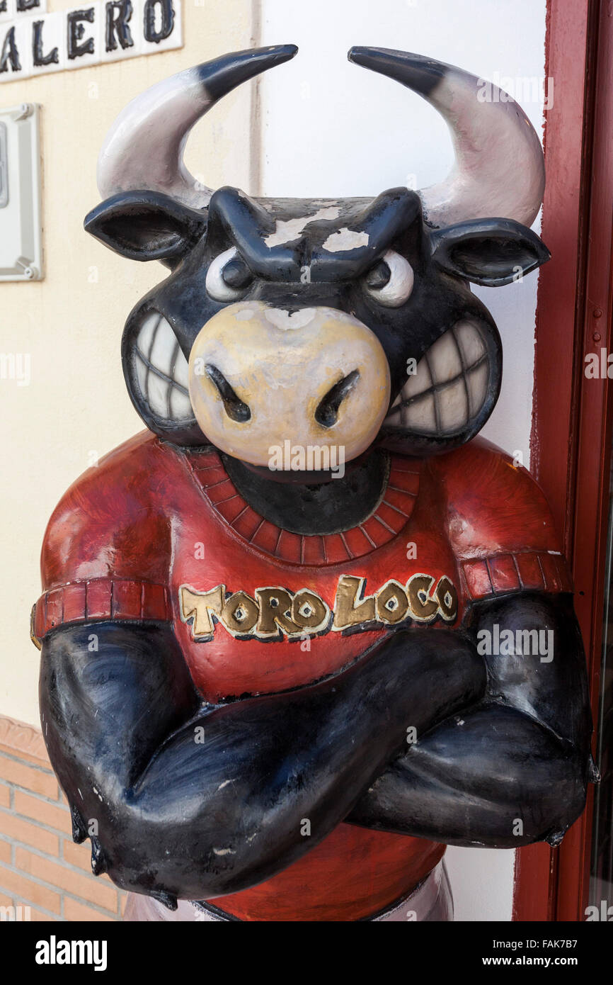 Funny figure of a quirky bull, toro, at the entrance to a bar in ...