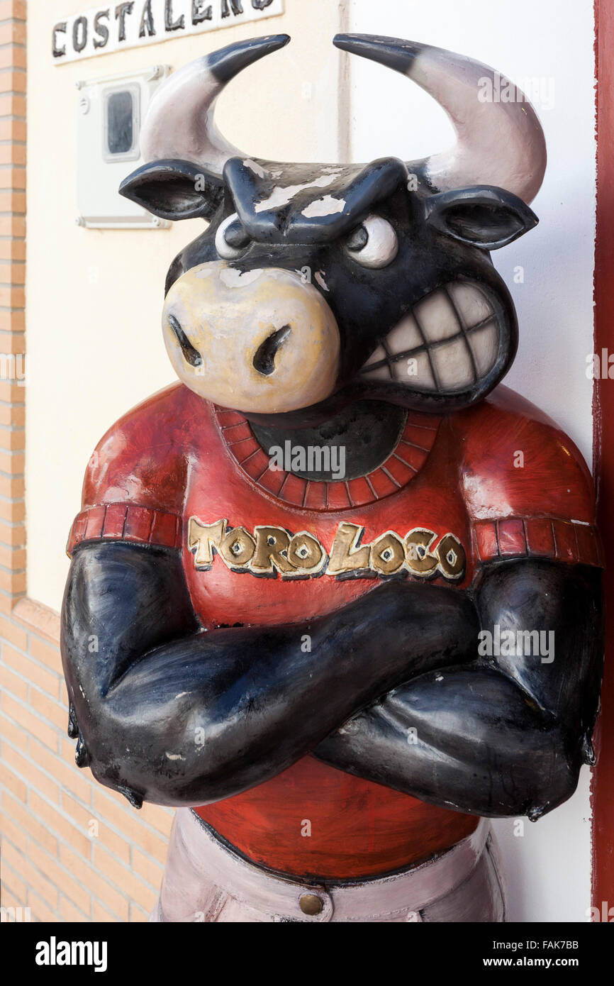 Funny figure of a quirky bull, toro, at the entrance to a bar in ...