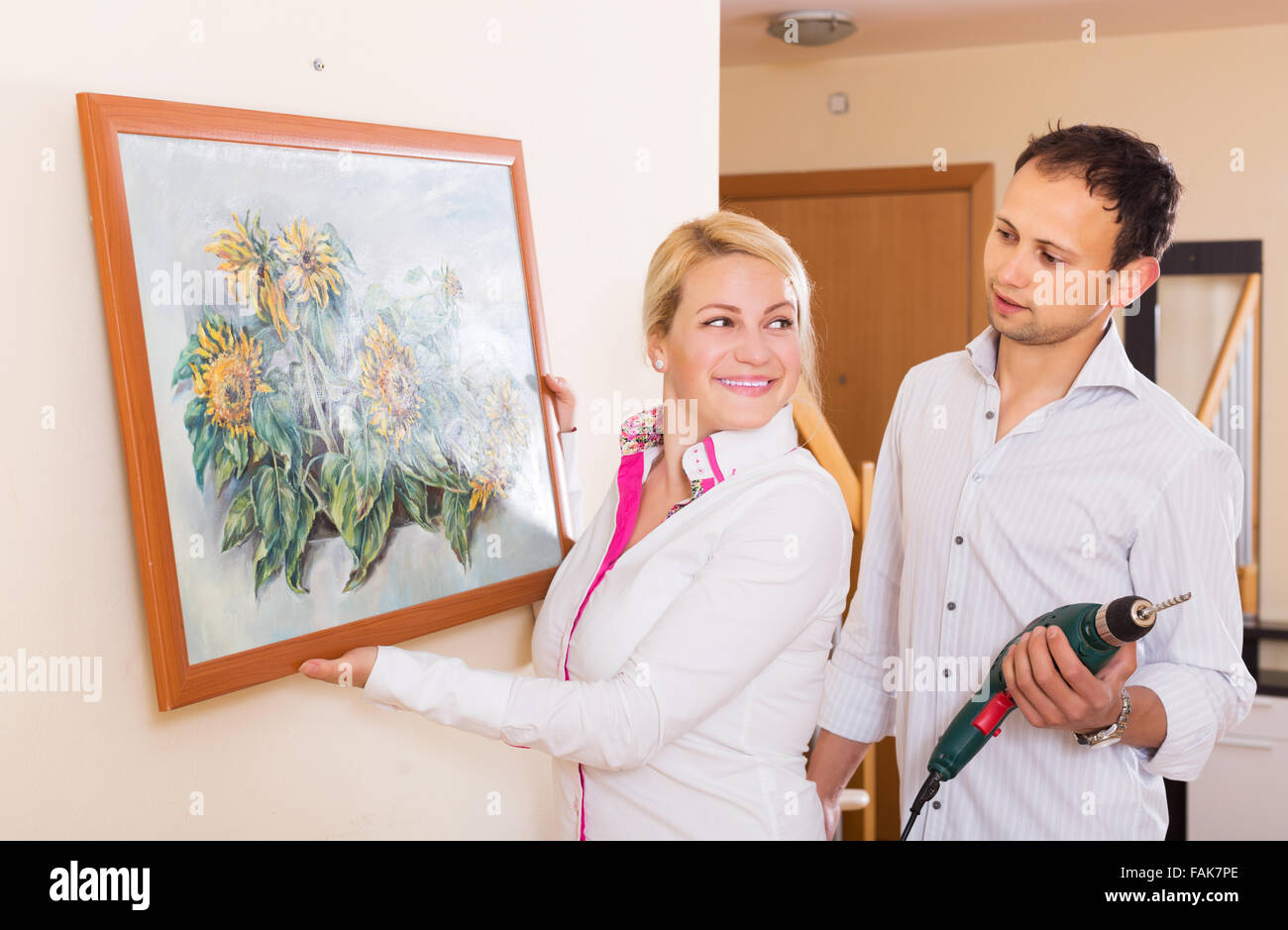 Family choosing place for picture at home Stock Photo - Alamy
