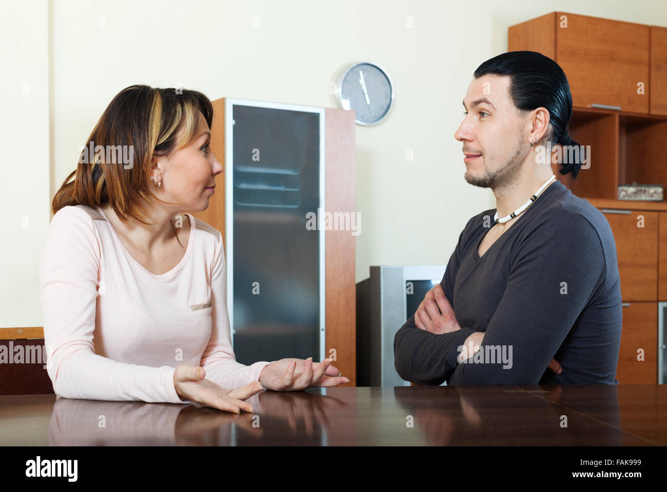 Ordinary couple having serious talking in home interior Stock Photo - Alamy