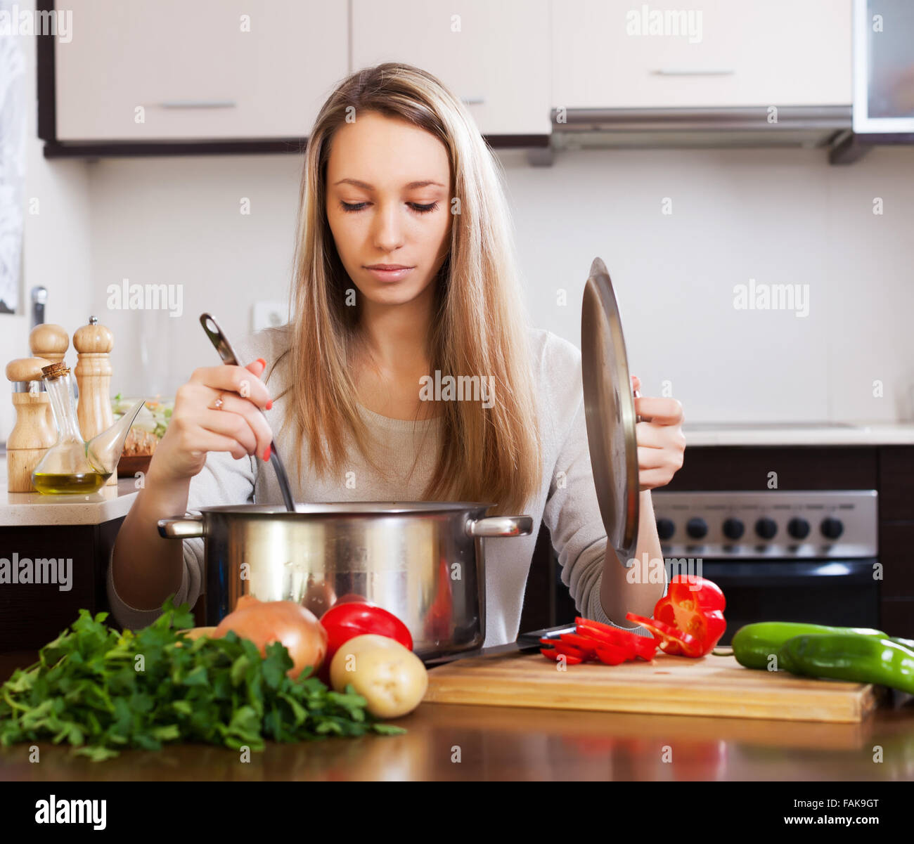 Ordinary woman with ladle cooking soup Stock Photo - Alamy
