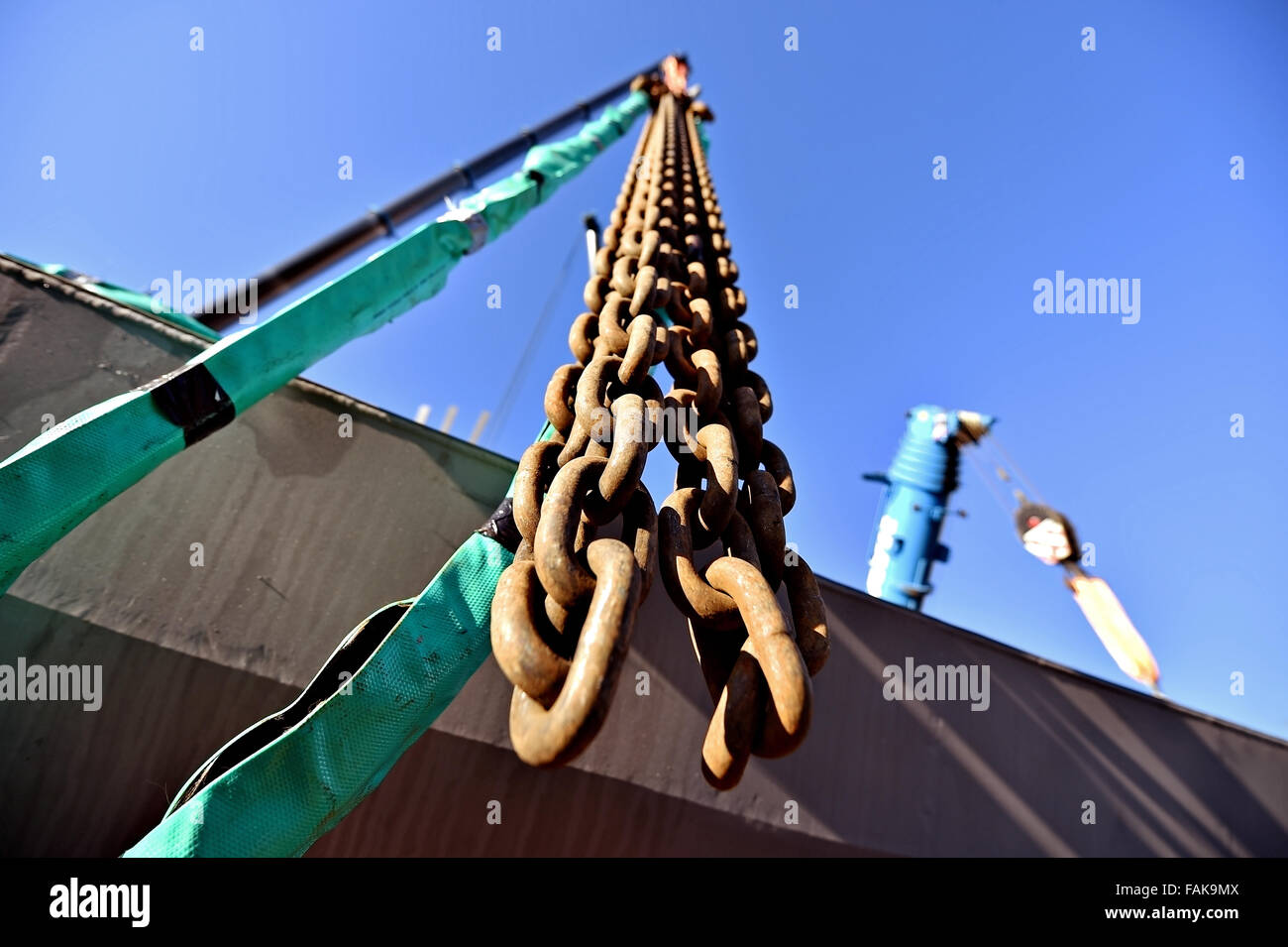 Heavy duty industrial chain hooked up on a construction crane Stock ...