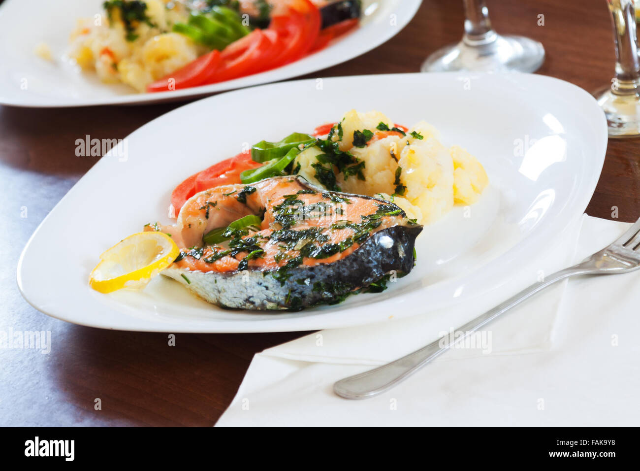 Grilled salmon fish on plate at table Stock Photo - Alamy