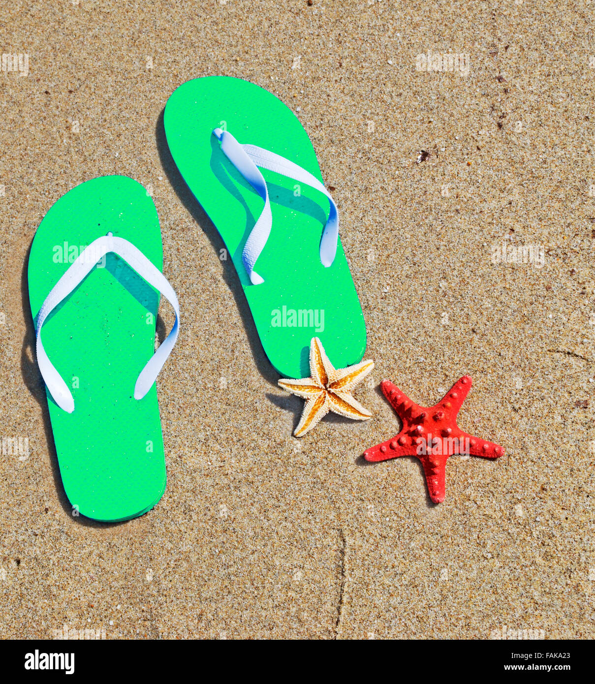 flip flops on the sand in a tropical beach Stock Photo - Alamy