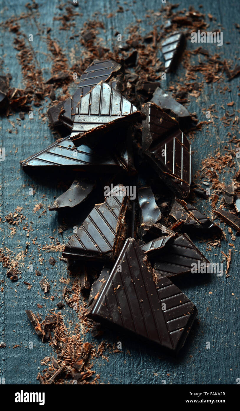 Shredded Dark Chocolate for Cooking on dark wooden background Stock ...