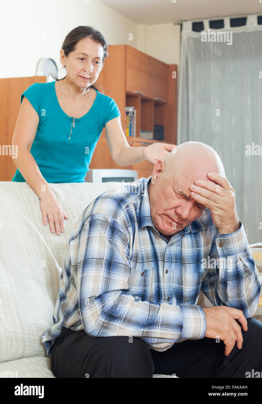 Upset senior man with angry wife at home Stock Photo - Alamy
