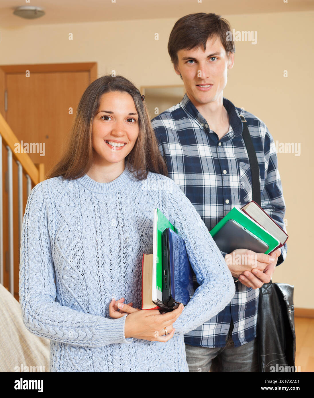 Smiling students couple at home Stock Photo - Alamy