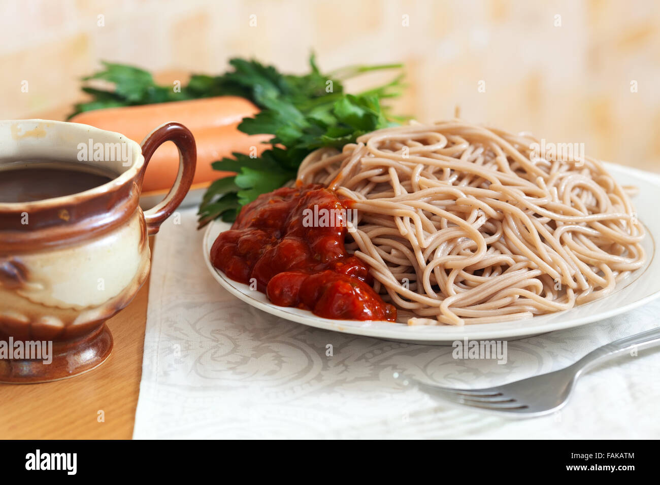 Supper. Boiled buckwheat spaghetti pasta with ketchup and sausages in ...