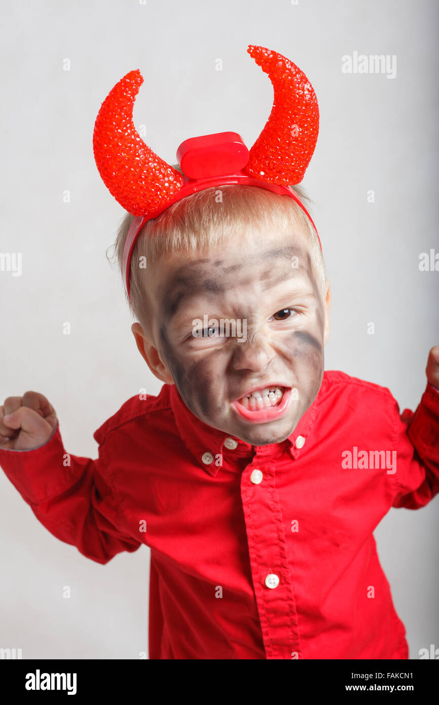 Little boy with trident in a devil costume (on white background Stock ...