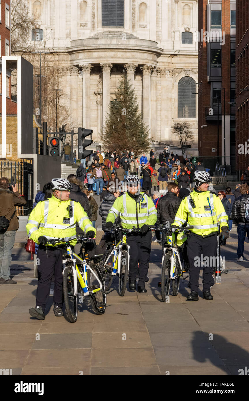 Police patrol on bicycles on the Millennium Bridge, London England ...