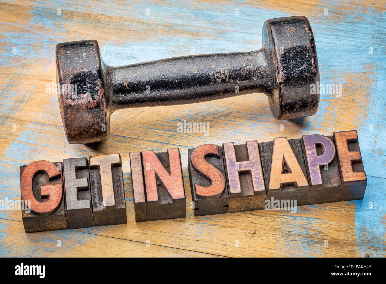 Dumbbell with get in shape text in vintage letterpress wood type ...