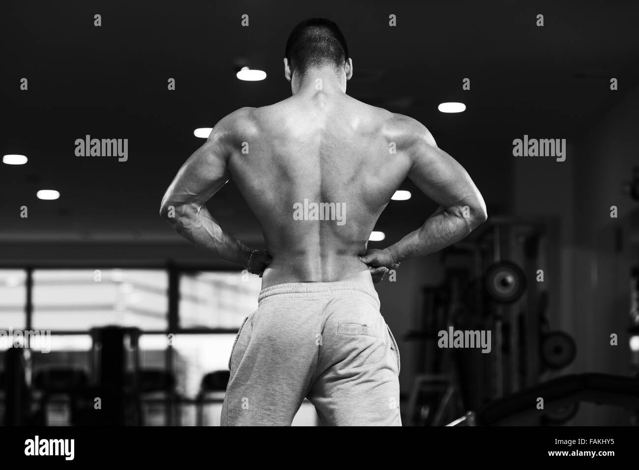 Awesome Bodybuilder Showing His Muscles And Posing In Gym Stock Photo ...