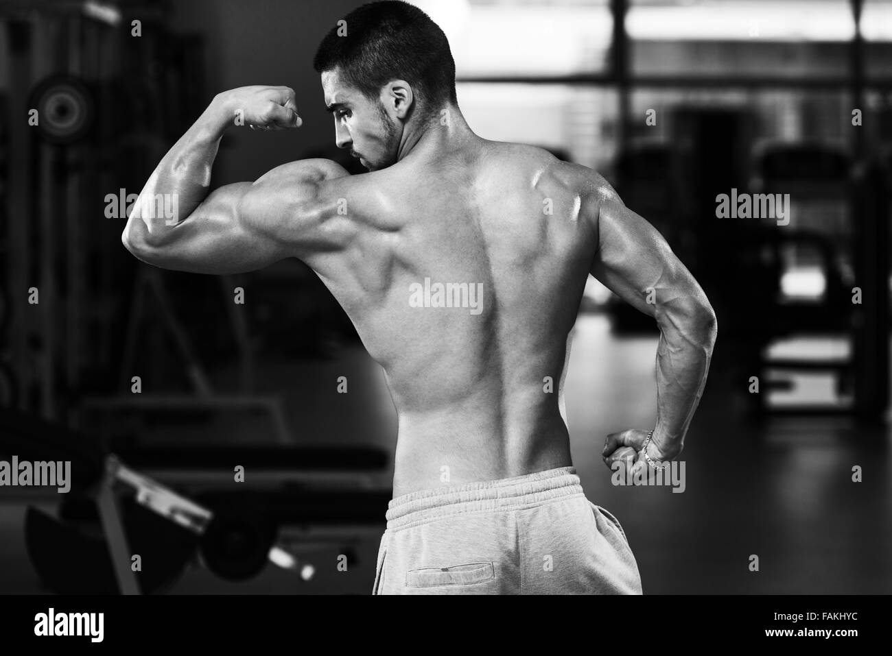 Man showing his muscles Black and White Stock Photos & Images - Alamy
