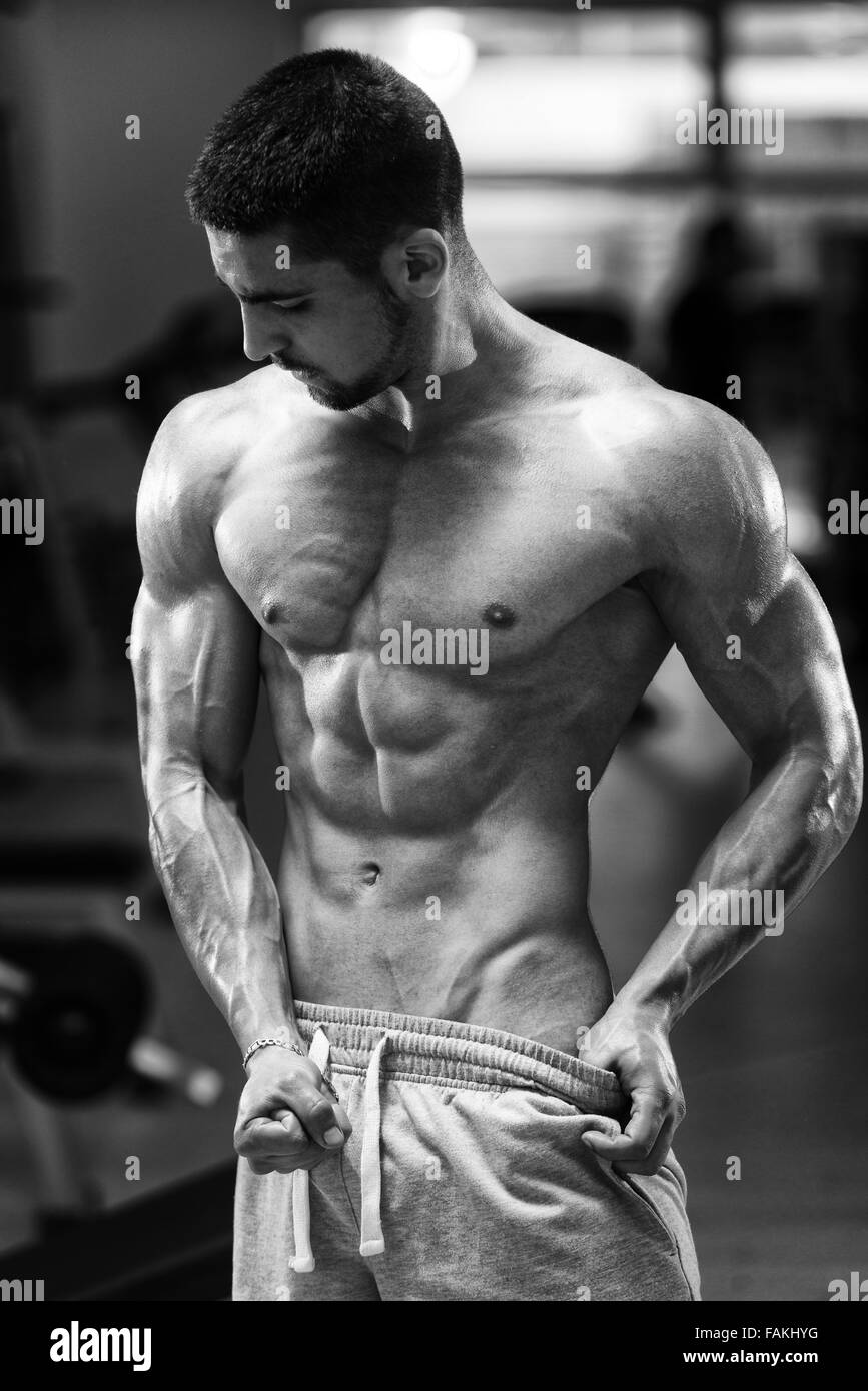 Awesome Bodybuilder Showing His Muscles And Posing In Gym Stock Photo ...