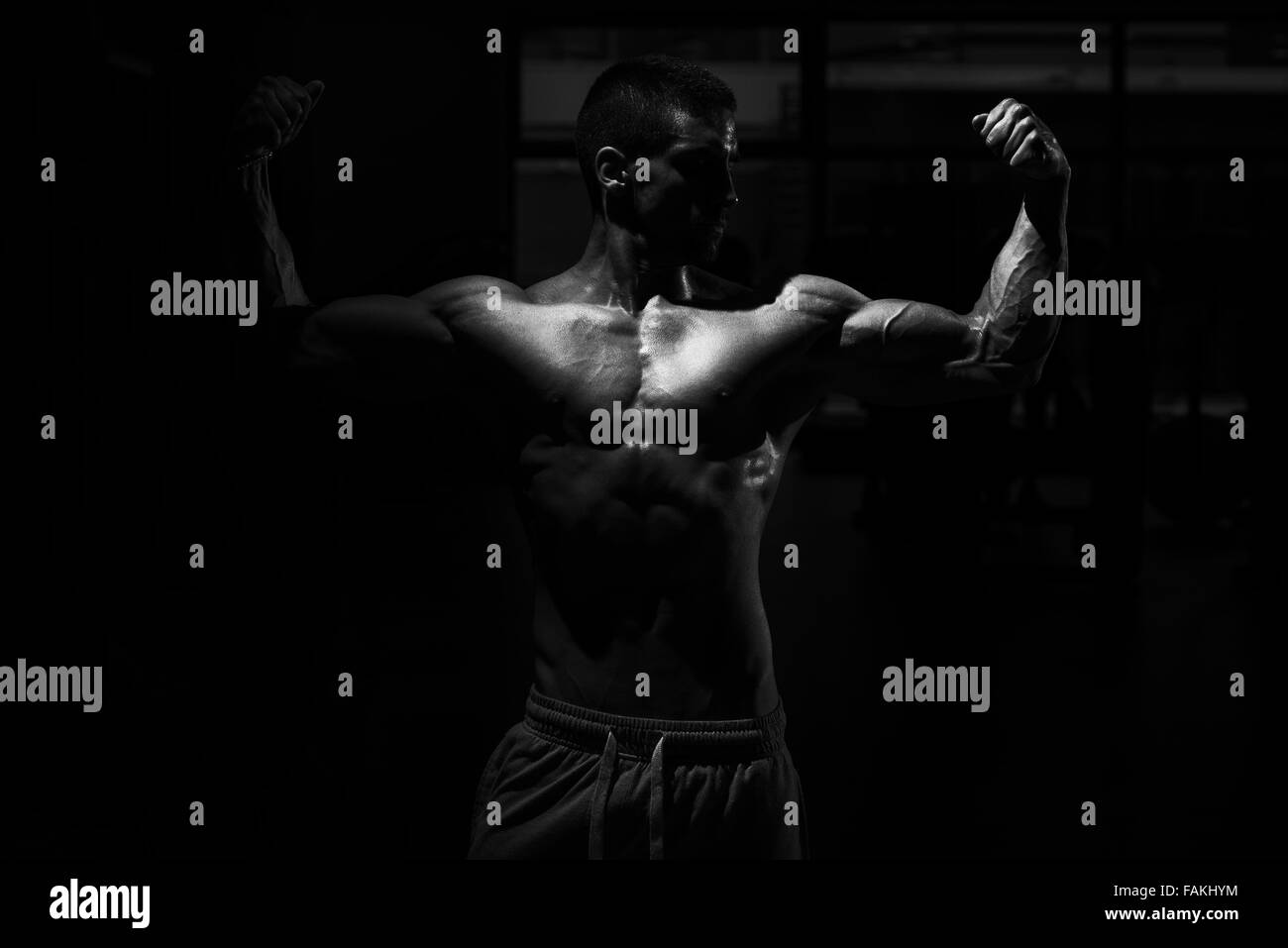 Muscular athlete in dark room Black and White Stock Photos & Images - Alamy