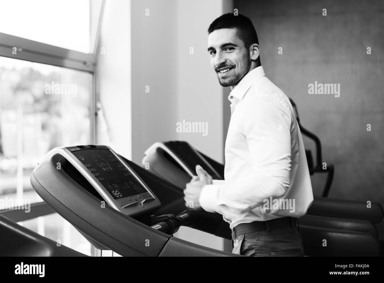 Businessman Running On Treadmill At A Health Club Stock Photo - Alamy