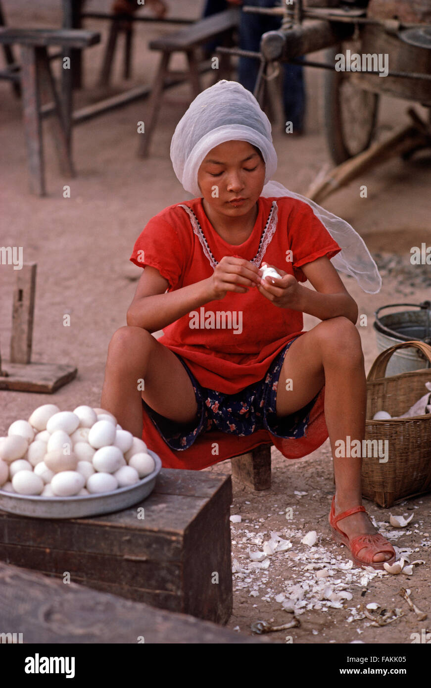 Uyghur girl peeling hard boil eggs in Turpan market, Xinjiang Province ...