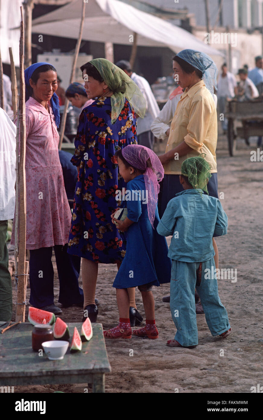 Uyghur women and children in Turpan market, Xinjiang Province, China ...