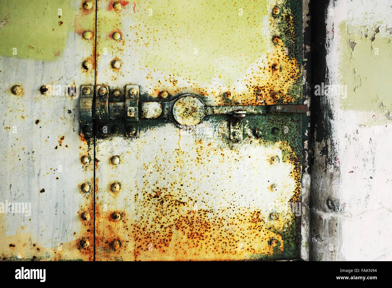 Rusty steel latch on closed yellow steel bunker tunnel door, Artillery ...