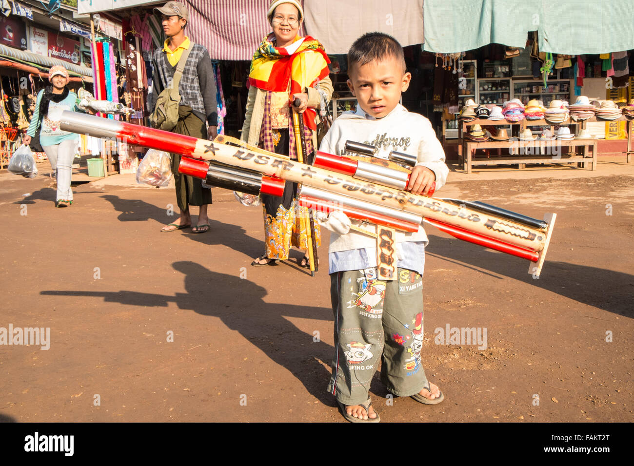 golden,rock,Myanmar,Burma,Kyaitiyo,Buddhist.Boy with toy USA military ...