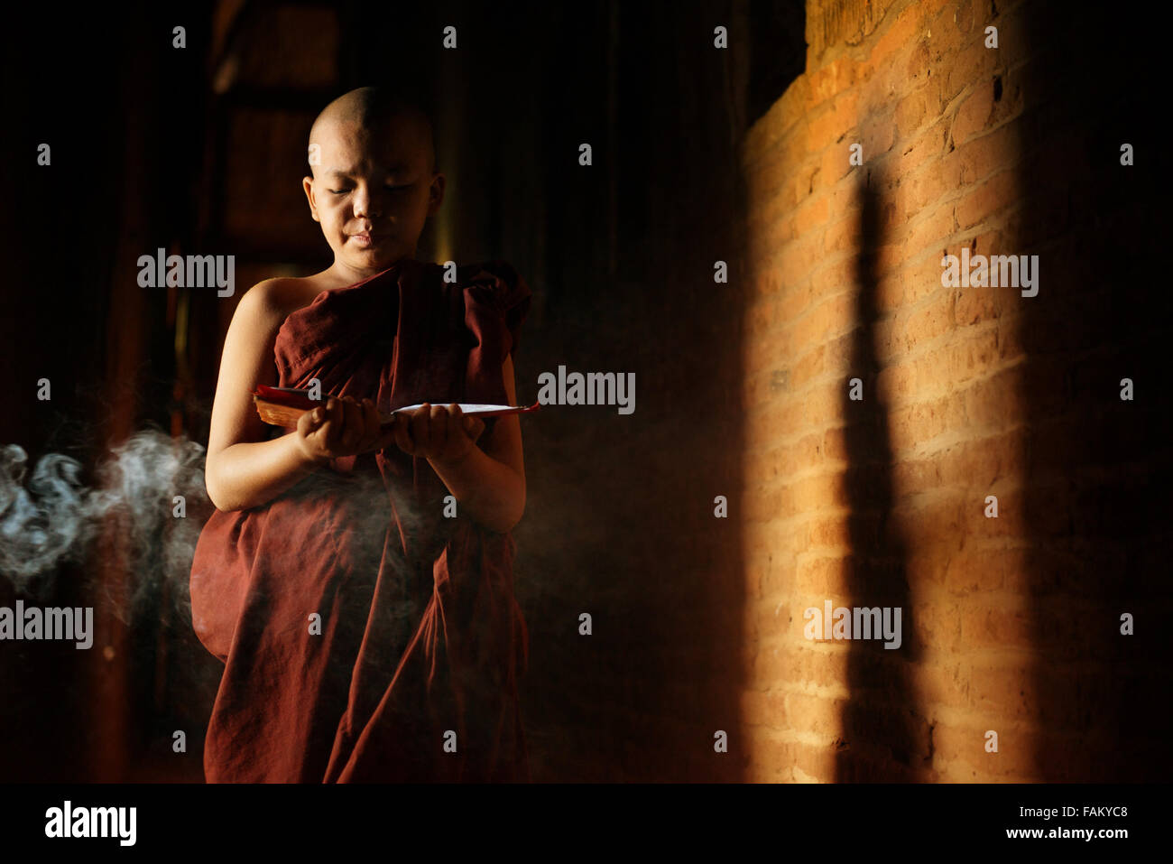 Young novice monk learning inside monastery Stock Photo - Alamy