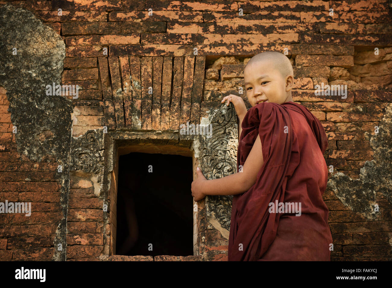 Young buddhist monk standing outside hi-res stock photography and ...