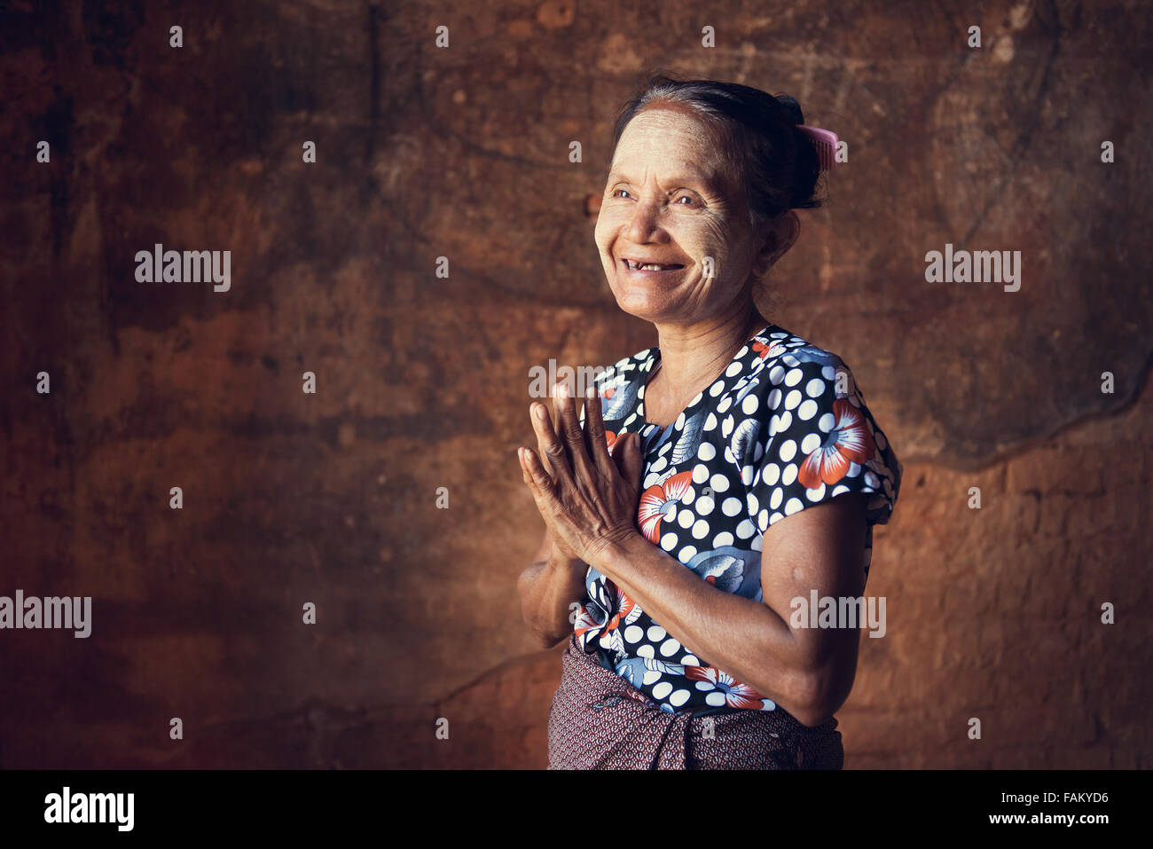 Portrait of traditional Asian Burmese woman greeting, standing inside a ...