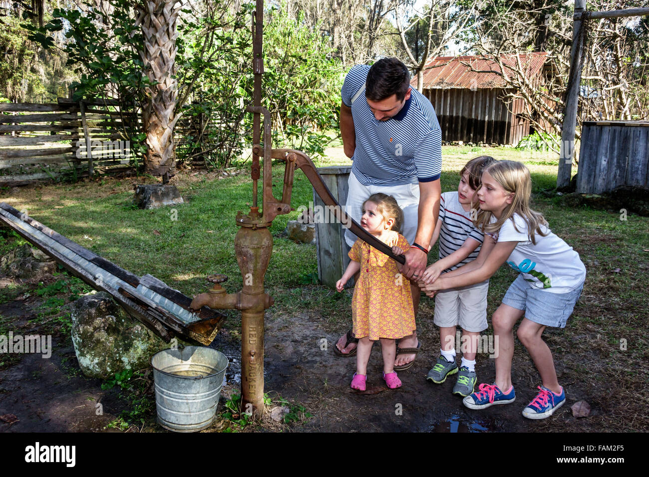 Child using water at water pump hi-res stock photography and images - Alamy