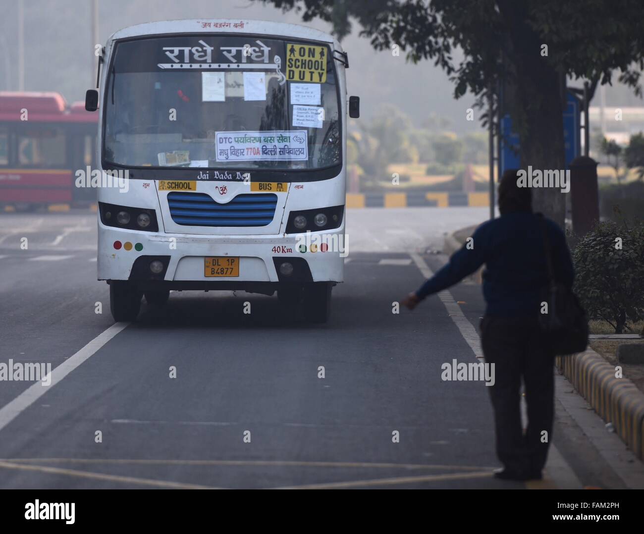 New Delhi, India. 1st Jan, 2016. A passenger waits for a shuttle bus ...