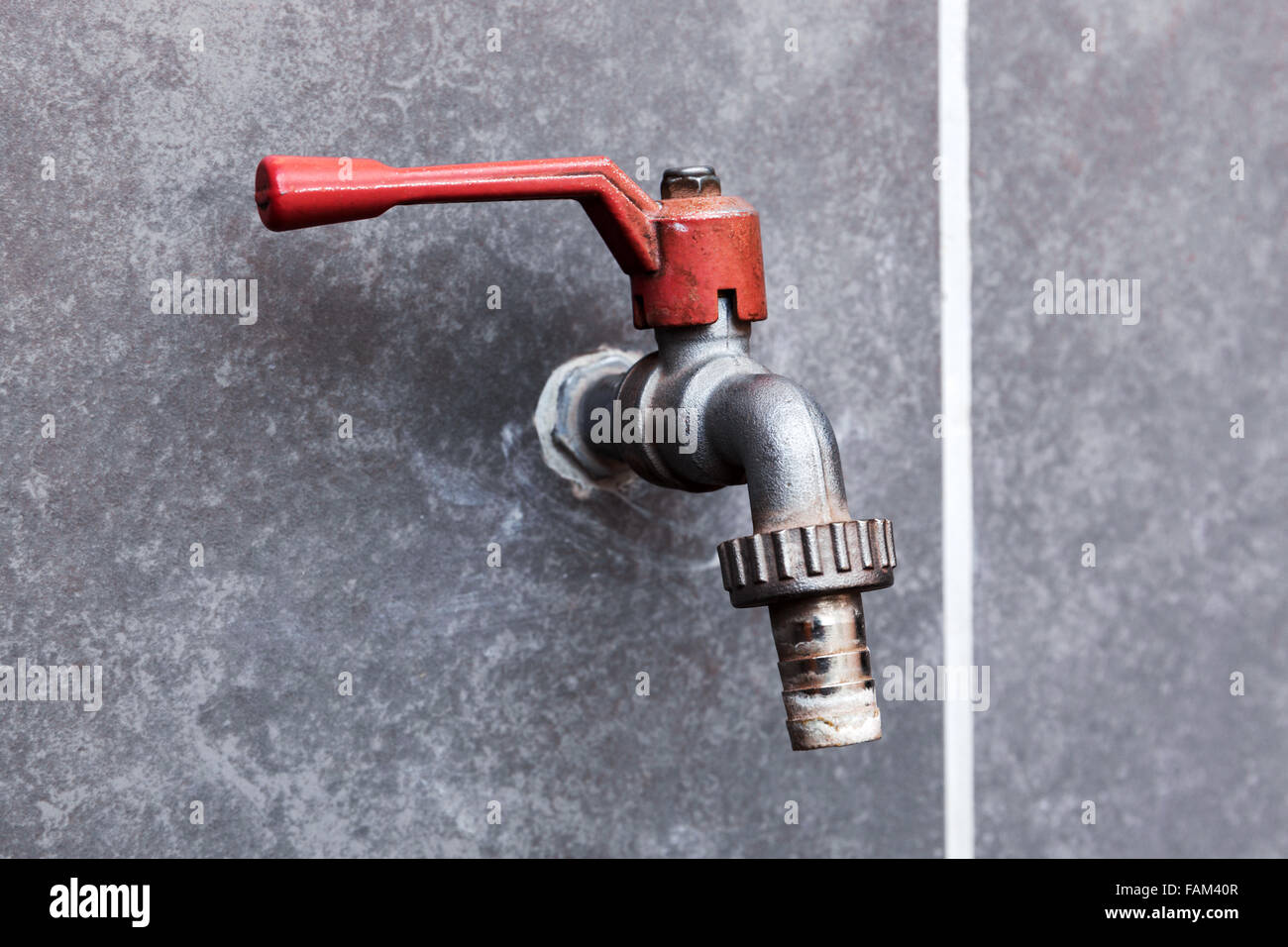 tap and a white line on a concrete wall Stock Photo - Alamy