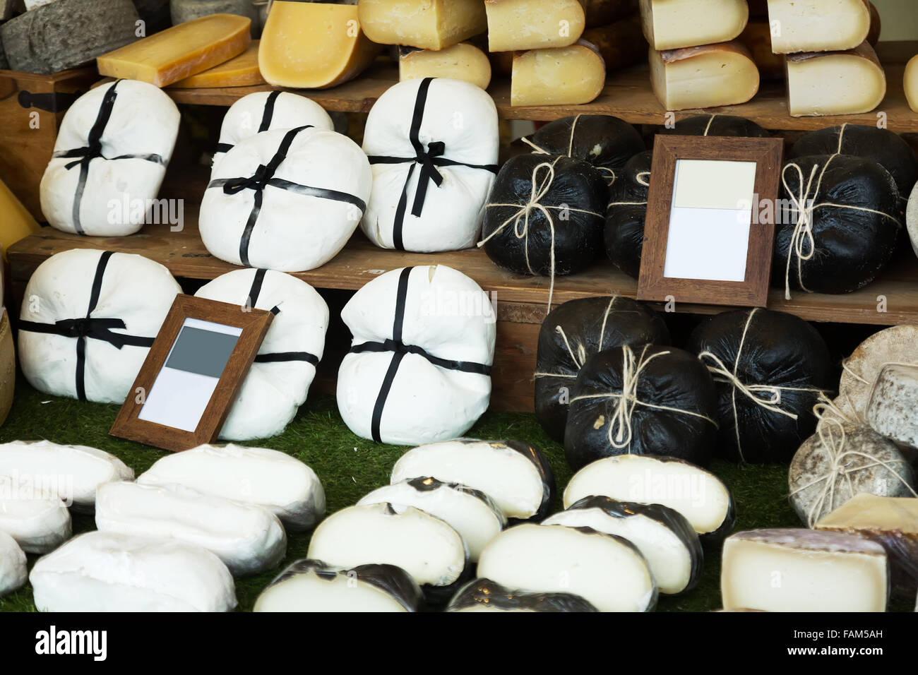 Market counter with caprine cheese kinds close up Stock Photo - Alamy