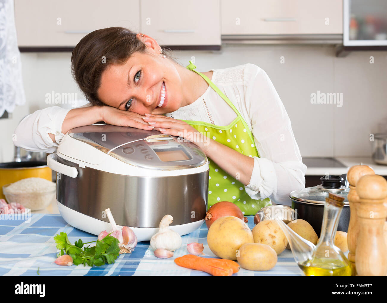 Happy young woman cooking with new multicooker in home interior Stock ...