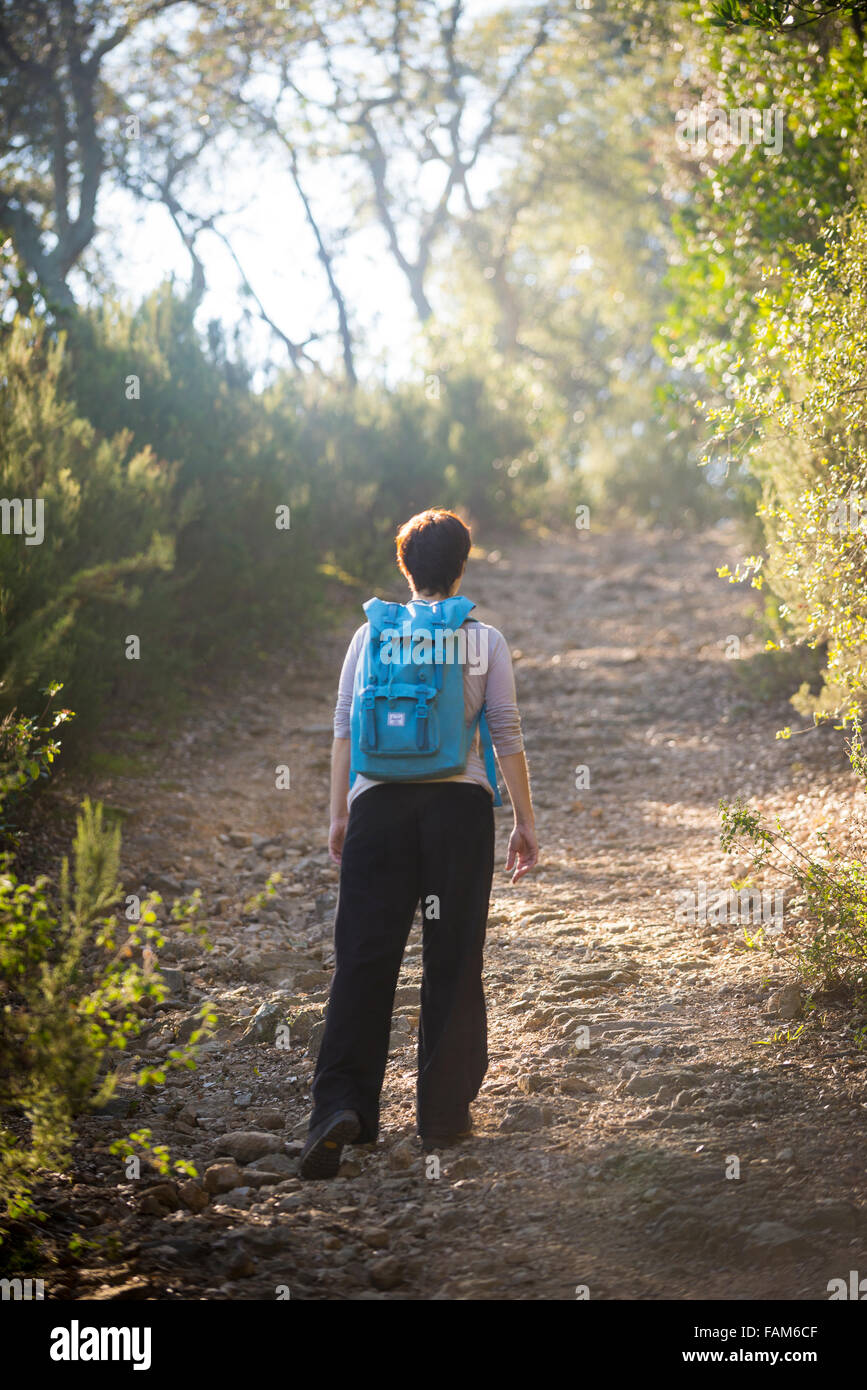 Woman with small backpack walks hi-res stock photography and images - Alamy