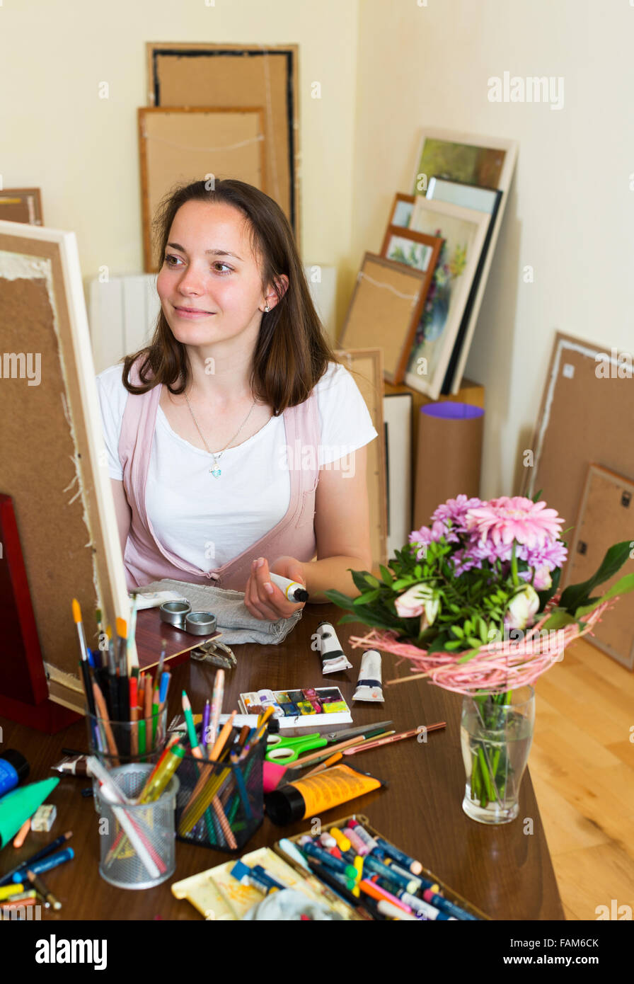 Positive artist in the process of creating a new picture Stock Photo ...