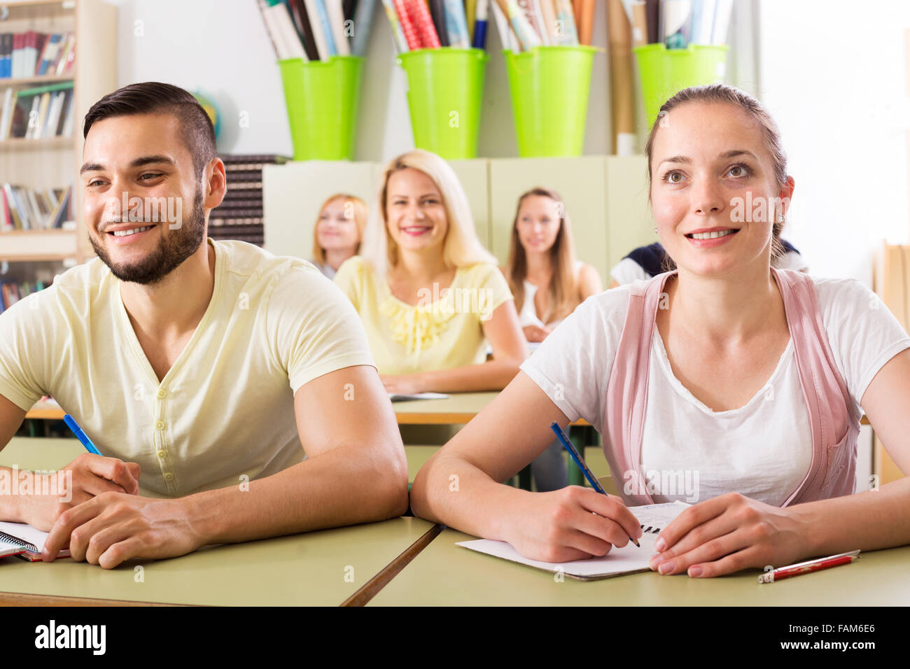 Young happy students studying in the classroom Stock Photo - Alamy