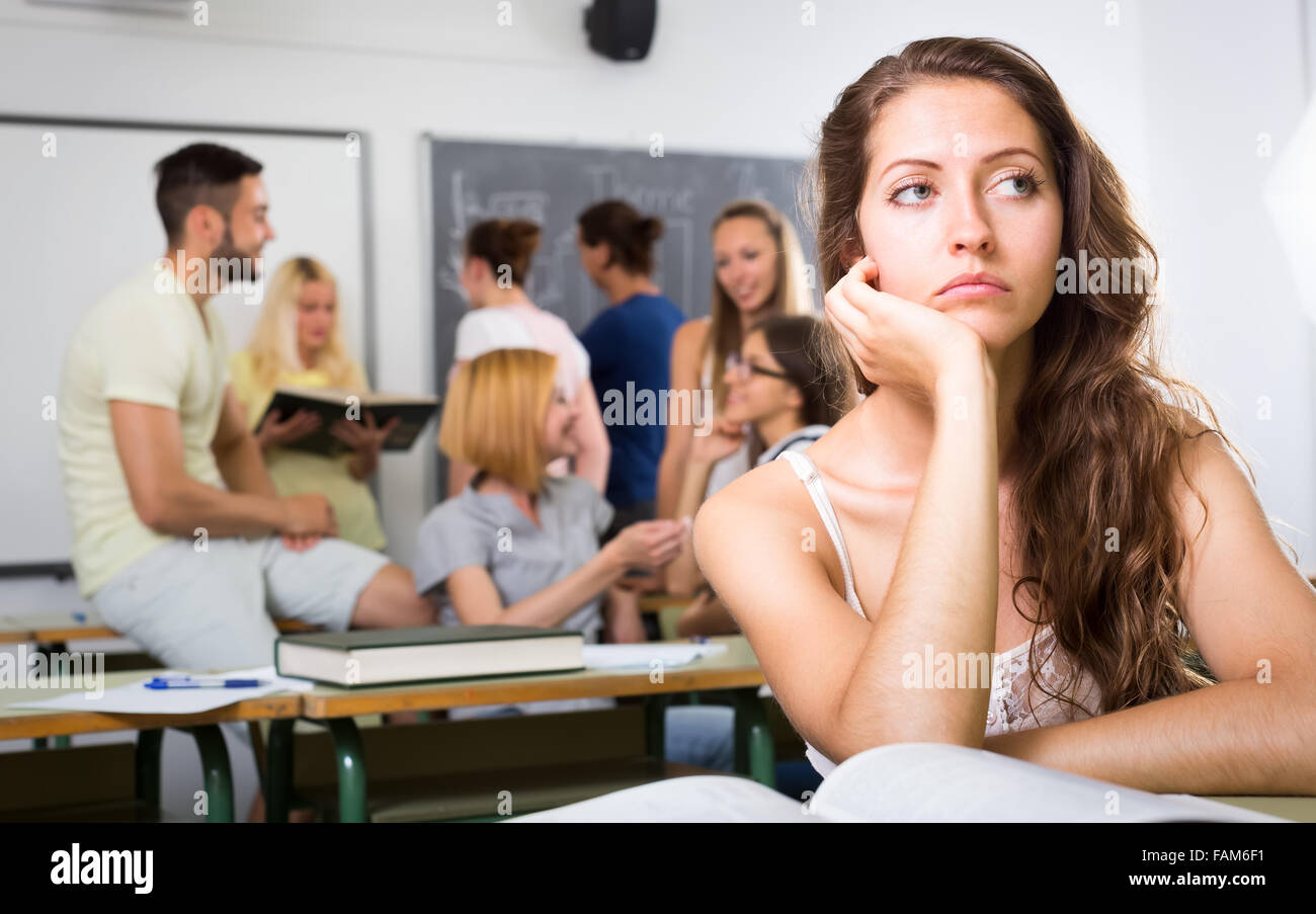 Bored lonely female student sitting in classroom at her desk Stock ...