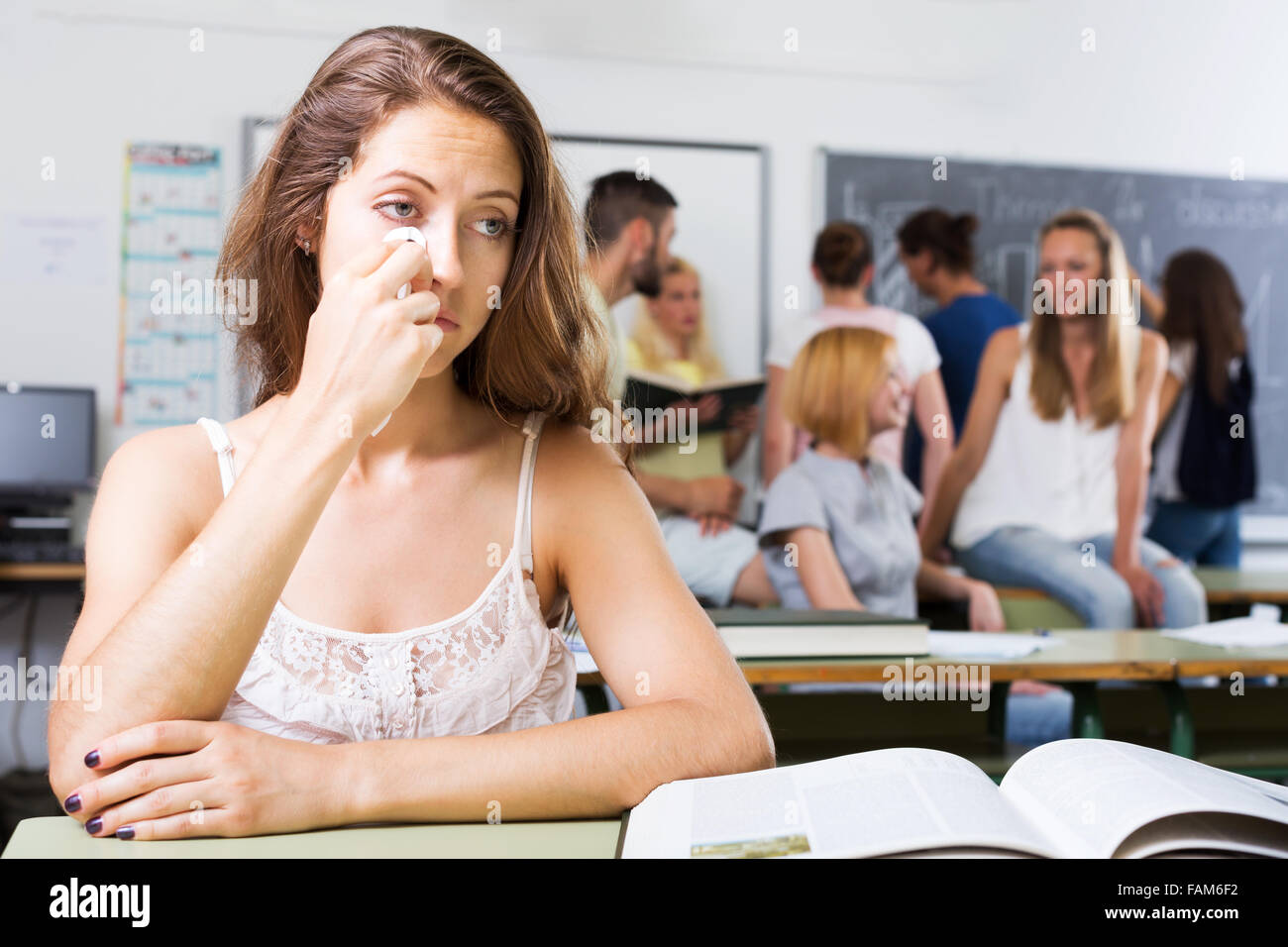 Dejected lonely student sits at her desk Stock Photo - Alamy